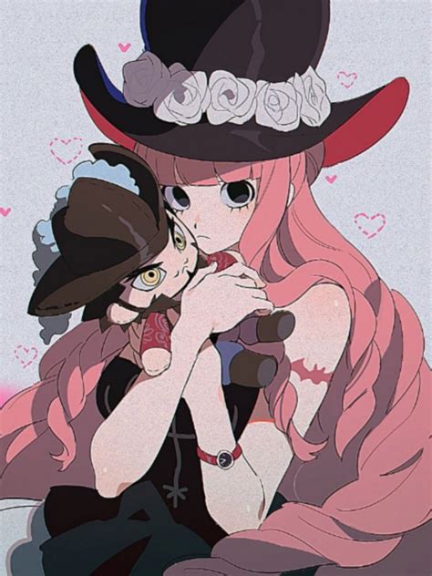 A Woman With Pink Hair Wearing A Black Hat And Sitting Next To A Man In