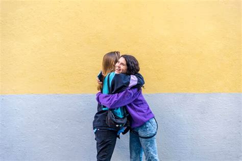 Premium Photo Young Friends Hugging Outdoors On The Street