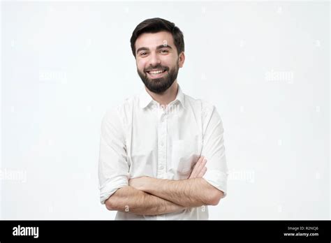 Portrait Of Smiling Handsome Man In White Shirt Standing With Crossed