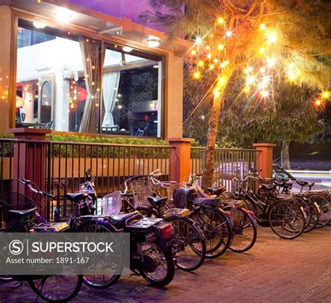 Bicycles Parked Under A Lit Up Tree Mandalay Myanmar Superstock