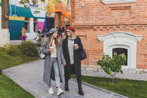 Premium Photo Young Female Best Friends Talking To Each Other