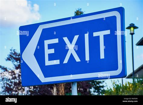 Blue Exit Sign In The Netherlands Against Blue Cloudy Sky And Trees Stock Photo Alamy