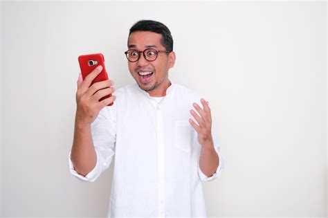 Premium Photo Adult Asian Man Showing Wow Face Expression While Looking To His Mobile Phone