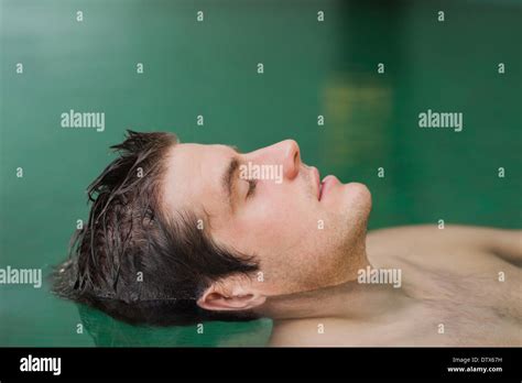 Handsome Man Floating In The Pool Stock Photo Alamy