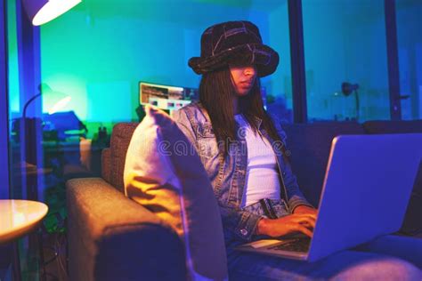 programmer hacker and woman typing on laptop in home at night in neon