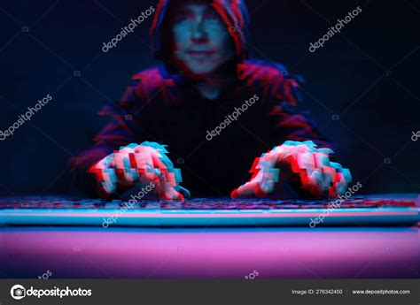 Hacker In The Hood Working With Computer Typing Text In Dark Room