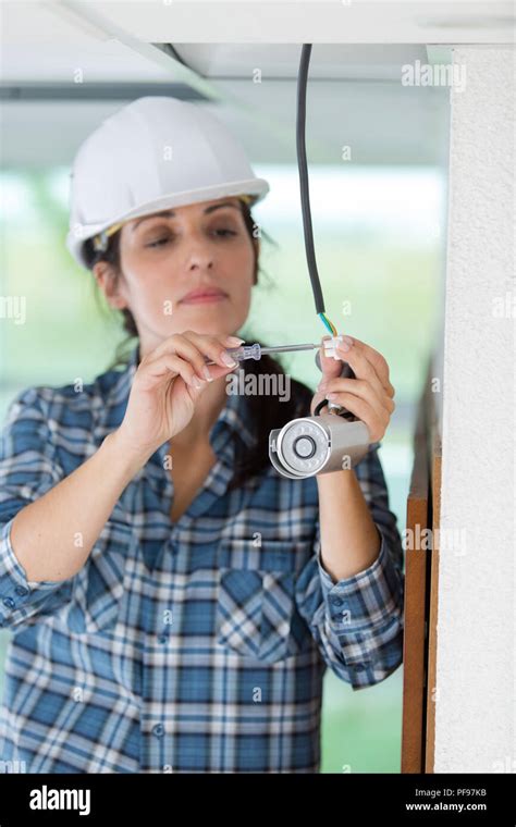 Woman Connecting The Cctv Wire Stock Photo Alamy