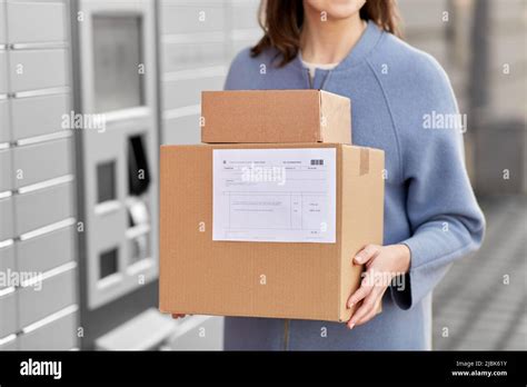 Woman With Boxes At Automated Parcel Machine Stock Photo Alamy