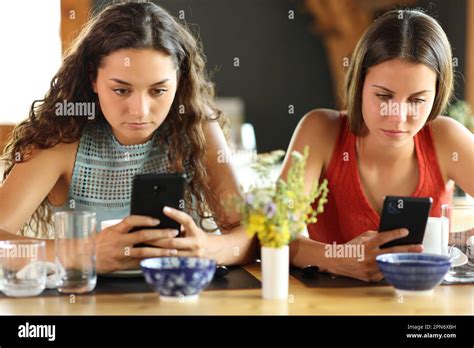 Women Using Mobile Phones Ignoring Hi Res Stock Photography And Images