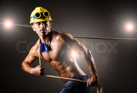 Nude Builder Pulling Rope In Darkness Stock Image Colourbox