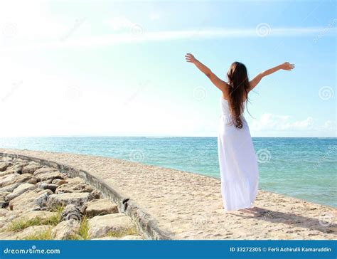 Woman Relaxing At The Beach With Arms Open Enjoying Her Freedom Stock
