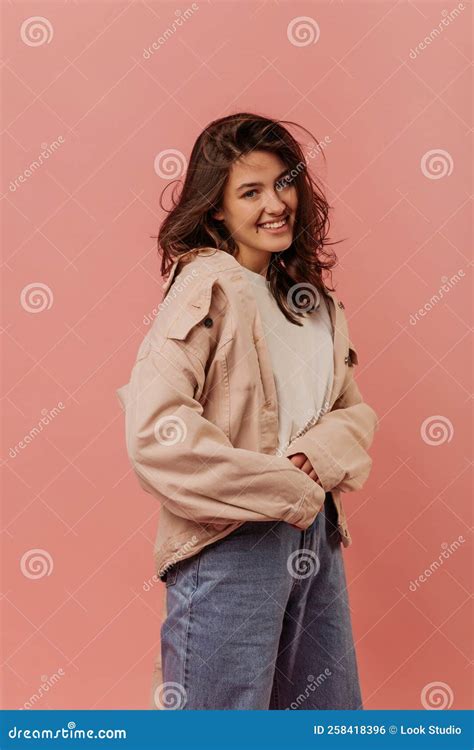 Stylish Young Brunette Caucasian Woman Is Smiling Looking At Camera On Pink Background Stock