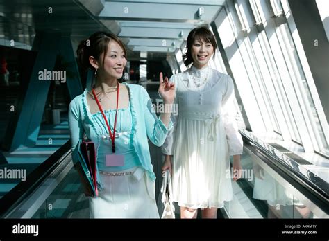 Two Women On An Escalator Stock Photo Alamy