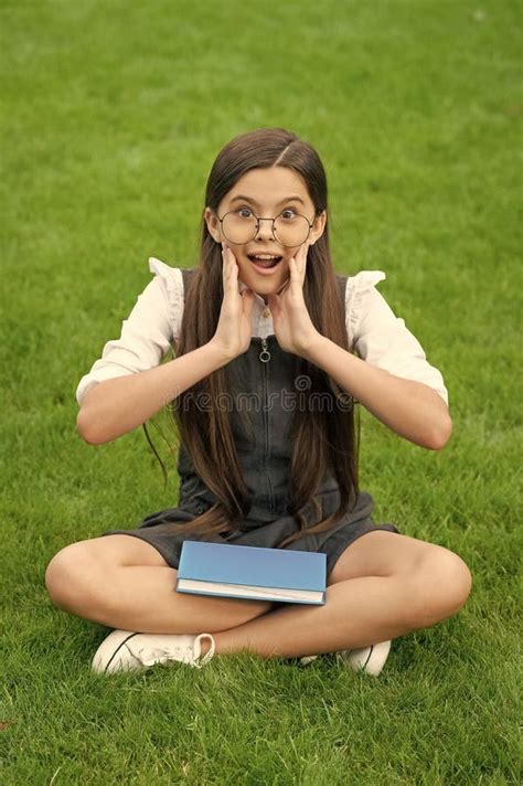 Shocked Teen School Girl Sitting Legs Crossed On Grass School And