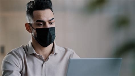 premium photo arabian sick businessman in medical mask designer programmer typing on laptop