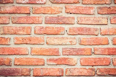 오렌지 벽돌 벽 콘크리트 또는 돌 질감 배경 벽지 석회암 추상 바닥 및 숙제 벽돌 또는 석조 깨끗한 그리드 고르지 내부 바위 오래된 공간을 복사합니다 0명에 대한 스톡 사진