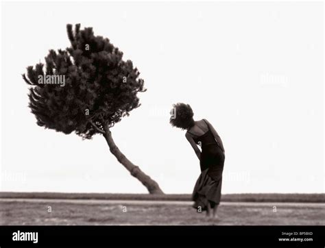Woman In Landscape Bending Body To Imitate Bending Tree Stock Photo Alamy