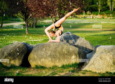 Female Contortionist Stretching On Boulder Battle Point Park
