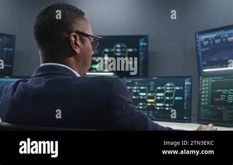 software programmer sits in front of computer with blockchain network