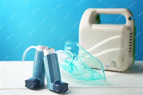 Premium Photo Asthma Inhalers And Nebuliser On Blue Background