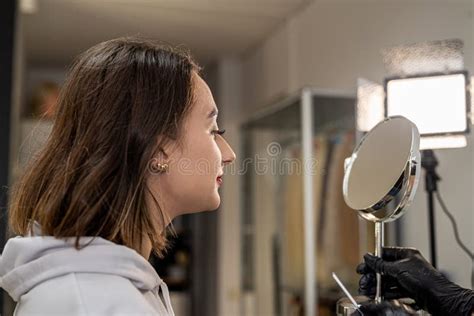 Beautiful Woman Checking Her Skin Looking In The Mirror Stock Image