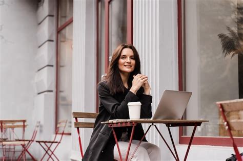 Premium Photo Attractive Girl Programmer With Laptop Is Working Online Outside Of Cafe On