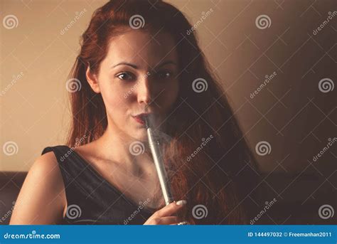 A Beautiful Caucasian Woman In A Black Dress Holds A Hookah Pipe In Her