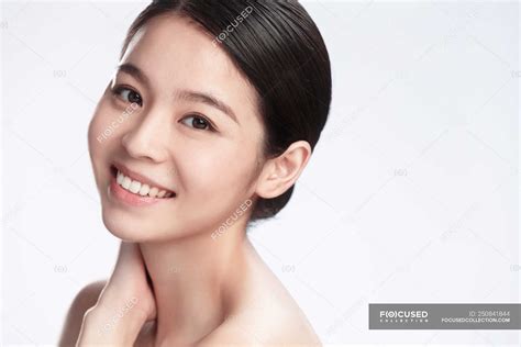 Portrait Of Elegant Happy Young Asian Woman Smiling At Camera Isolated
