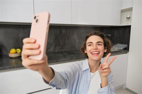 Premium Photo Happy Beautiful Brunette Girl Takes Selfie At Home