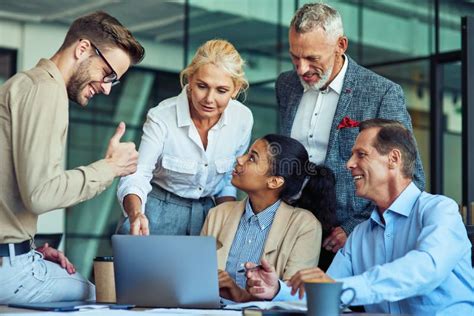 Successful Multiracial Business Team Standing In The Modern Office Communicating And Discussing