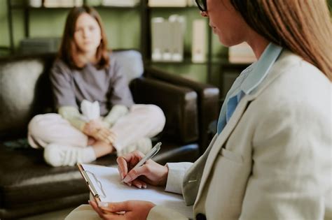 Premium Photo Counseling Session With Therapist Taking Notes On Clipboard