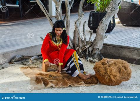 Young Maldivian Couple Dressed In National Clothes Cooking Food
