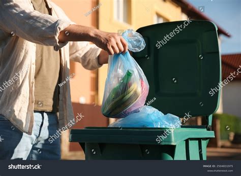 Man Throwing Trash Bag Into Bin Stock Photo Shutterstock