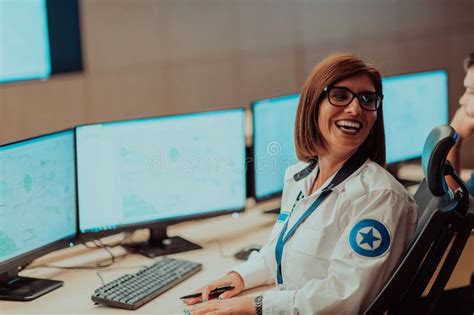 Female Security Operator Working In A Data System Control Room Offices