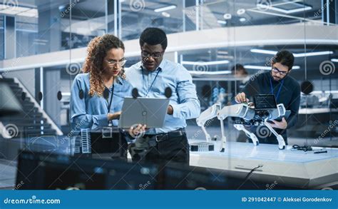 Portrait Of Two Multiethnic Female And Male Engineers Use Laptop Computer To Connect Analyze