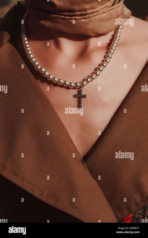 Female Fashion Pearl Beads With A Tiny Cross Hanging On The Neck Stock