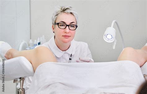 Gynecologist With Syringe Makes An Injection To Patient In Gynecology Chair Stock Photo Adobe
