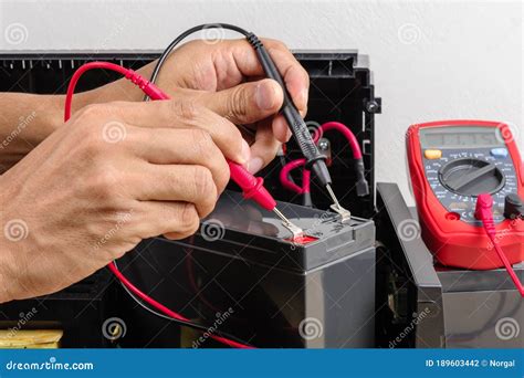 Testing The Battery With Multimeter Stock Photo Image Of Energy Device 189603442