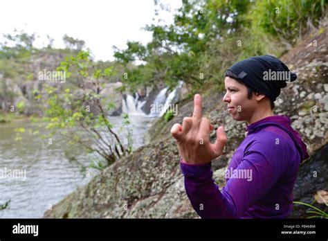 An Annoyed Woman Sticking Her Finger Up At The Camera Hi Res Stock