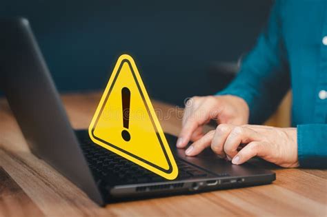 Man Using A Computer Laptop With Triangle Caution Warning Sign For