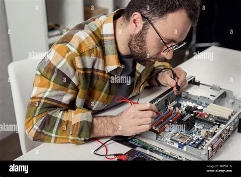 Man Using Multimeter While Fixing Computer Motherboard Stock Photo Alamy