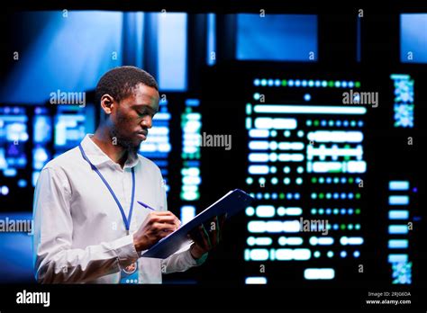 Licensed It Admin Walking In Server Hub Performing Data Backups And