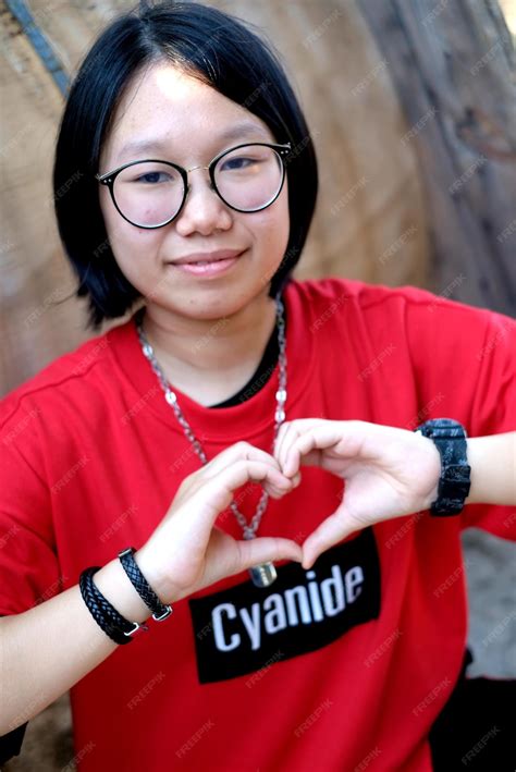 Premium Photo Portrait Of Girl Making Heart Shape Gesture