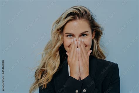 Shy Blonde Girl Covering Her Mouth With Hands And Feeling Excited Stock