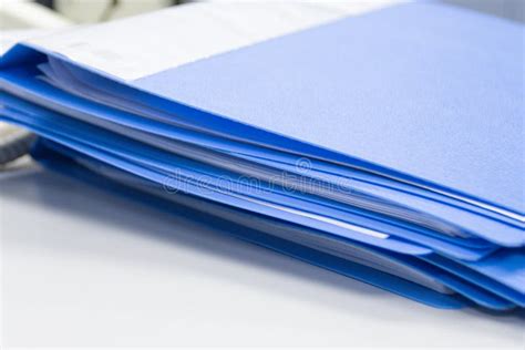 File Folder And Stack Of Business Report Paper File On The Table Stock