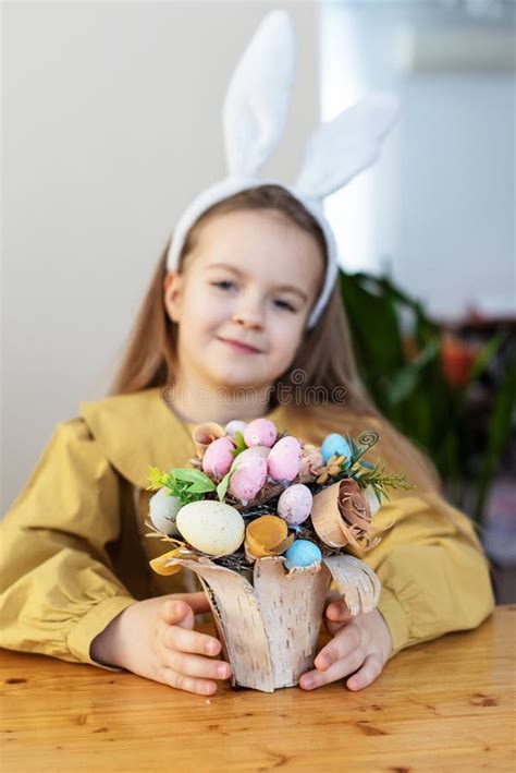 Caucasian Young Girl With Bunny Ears Holding Easter Decorated Basket Of