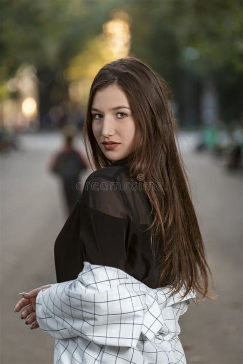 Raven Haired Beauty A Young Woman In A Wing Shaped Headpiece Standing