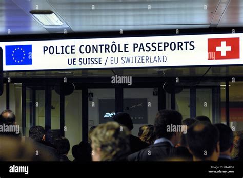 Passengers At The Eu And Swiss Passport Control Desk In The Arrivals