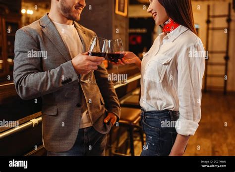 Man And Woman Drinks Red Wine At Wooden Bar Counter Couple Leisures In Pub Husband And Wife