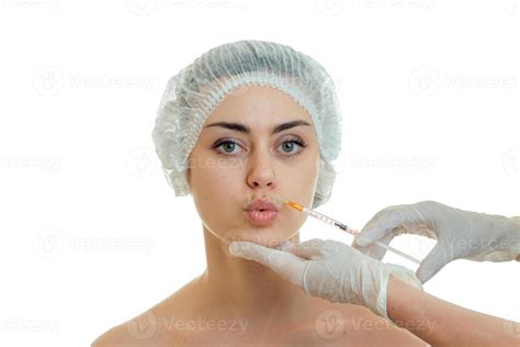 Young Beautiful Girl In Medical Hair Hat Looks Straight Makes Lips Kiss And The Doctor Puts
